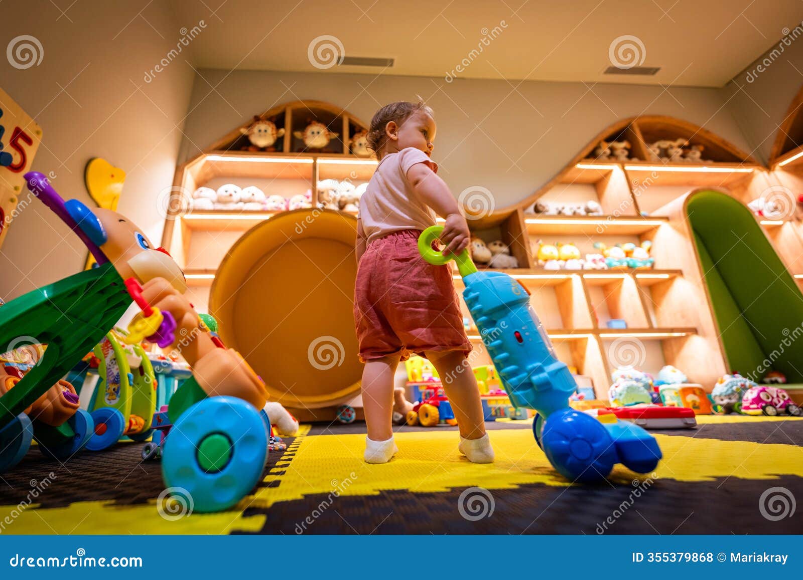 Child Exploring with a Toy Vacuum Cleaner in a Vibrant and Interactive ...