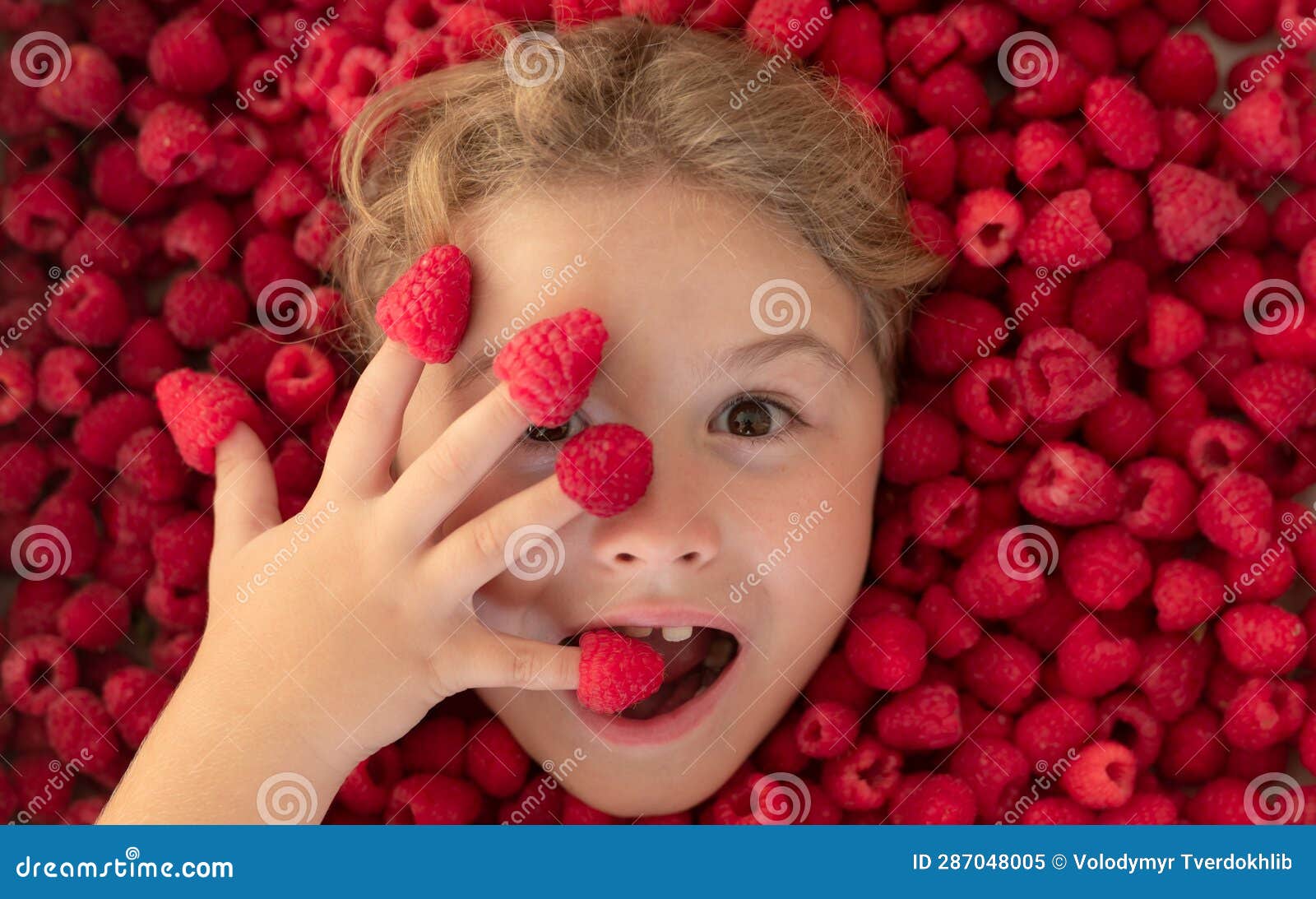 Child Face with Raspberry Frame, Close Up Raspberry Background. Stock ...