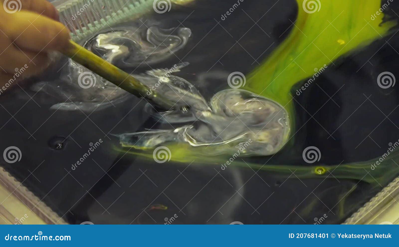 Child with Father Making Marble Patterns with Paint and Brush on Water ...