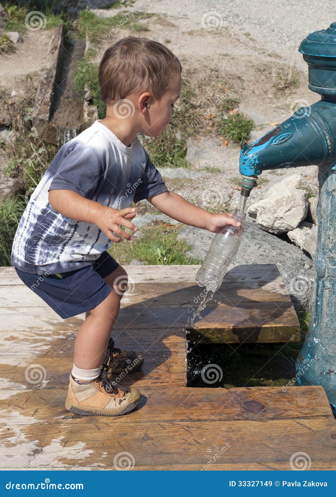 Child filling water bottle stock image. Image of natural - 33327149