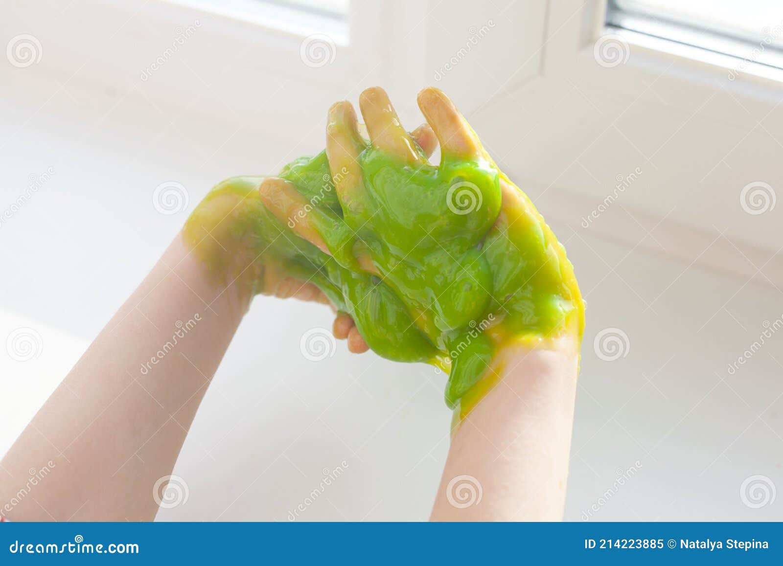 The Child Folded His Hands Together in a Green Bright Slime Stock Image ...
