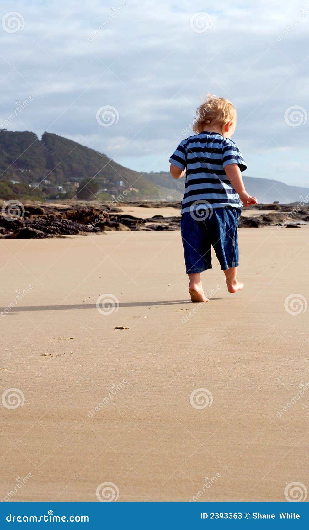 Child footsteps in sand stock image. Image of ocean, cloud - 2393363