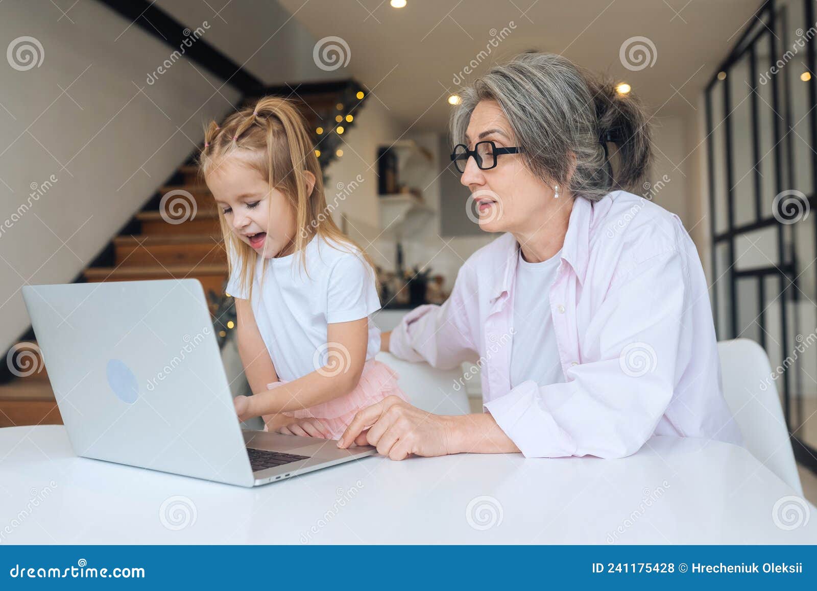 Child and Granny Looking at the Camera with Laptop Stock Photo - Image ...