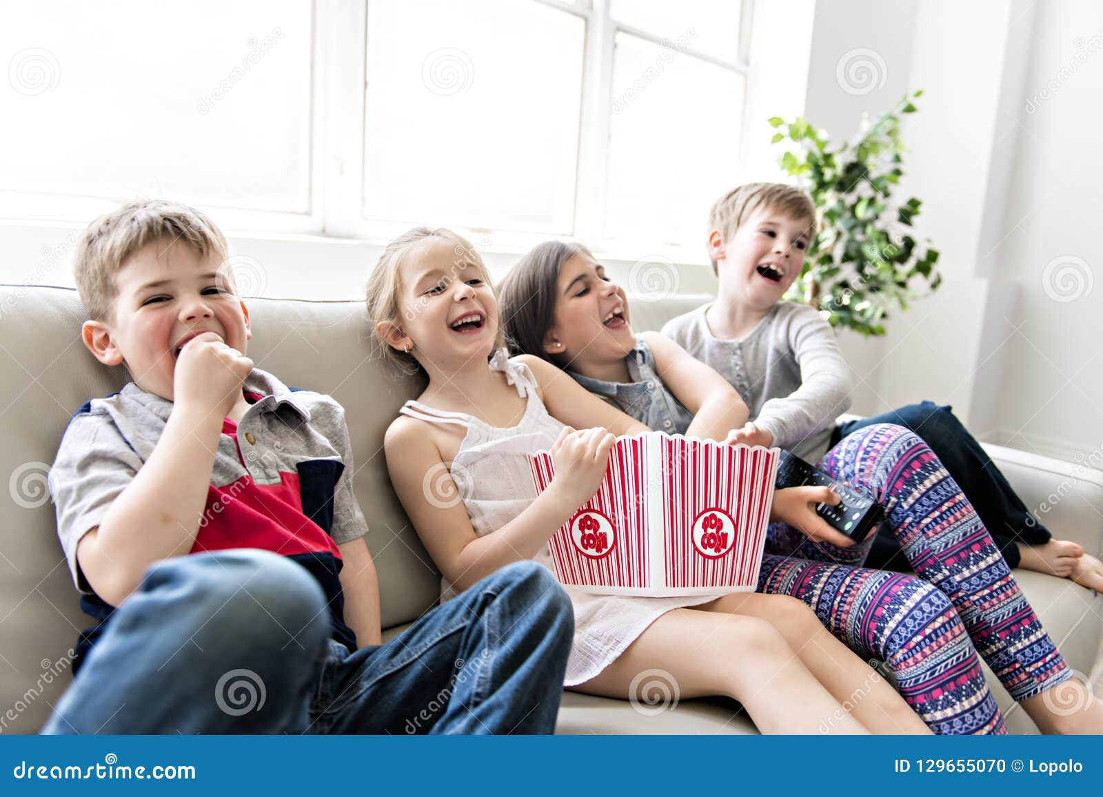 Child Group Eating Popcorn Together on Sofa Stock Photo - Image of ...