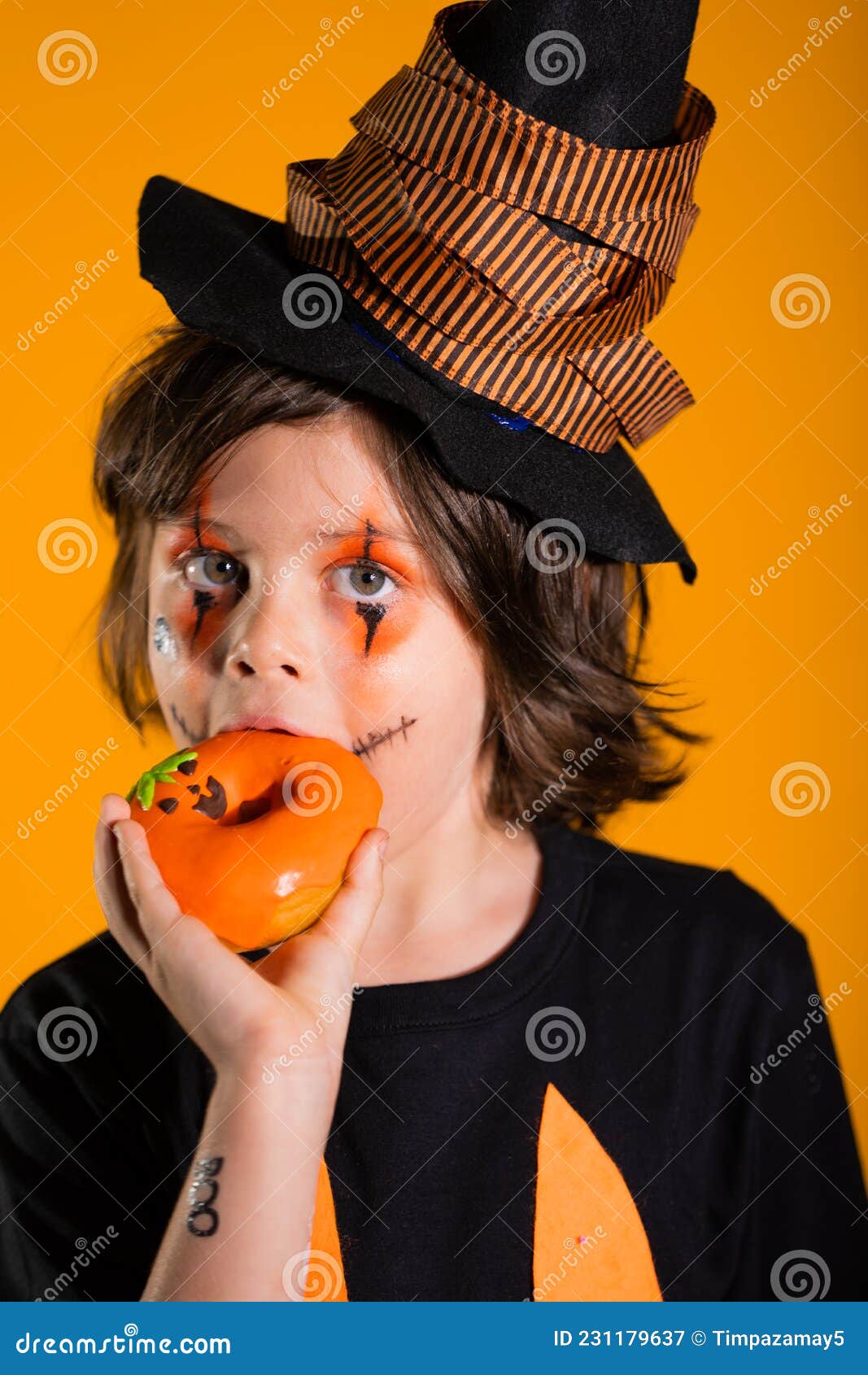 Child with Halloween Donut Doing Poses on Orange Background Stock Image ...
