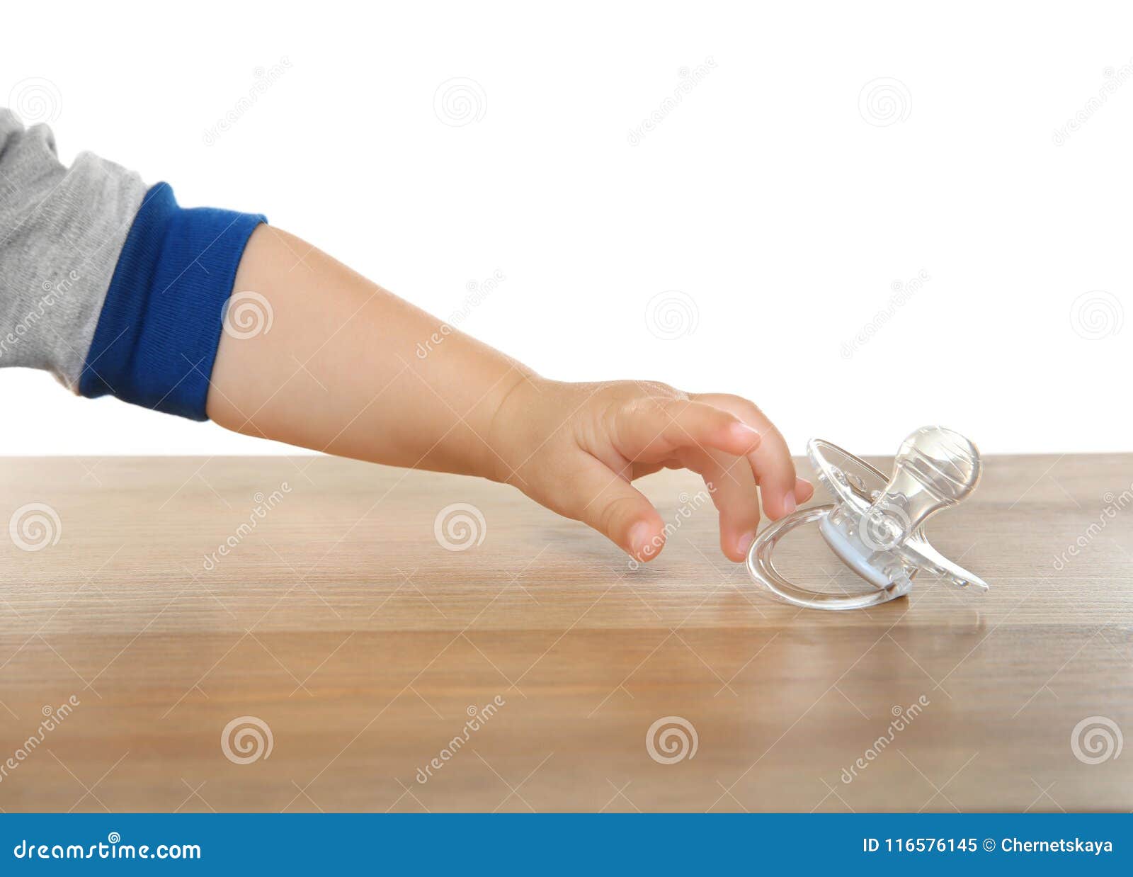 Child Hand with Pacifier on Table Stock Image - Image of baby, person ...