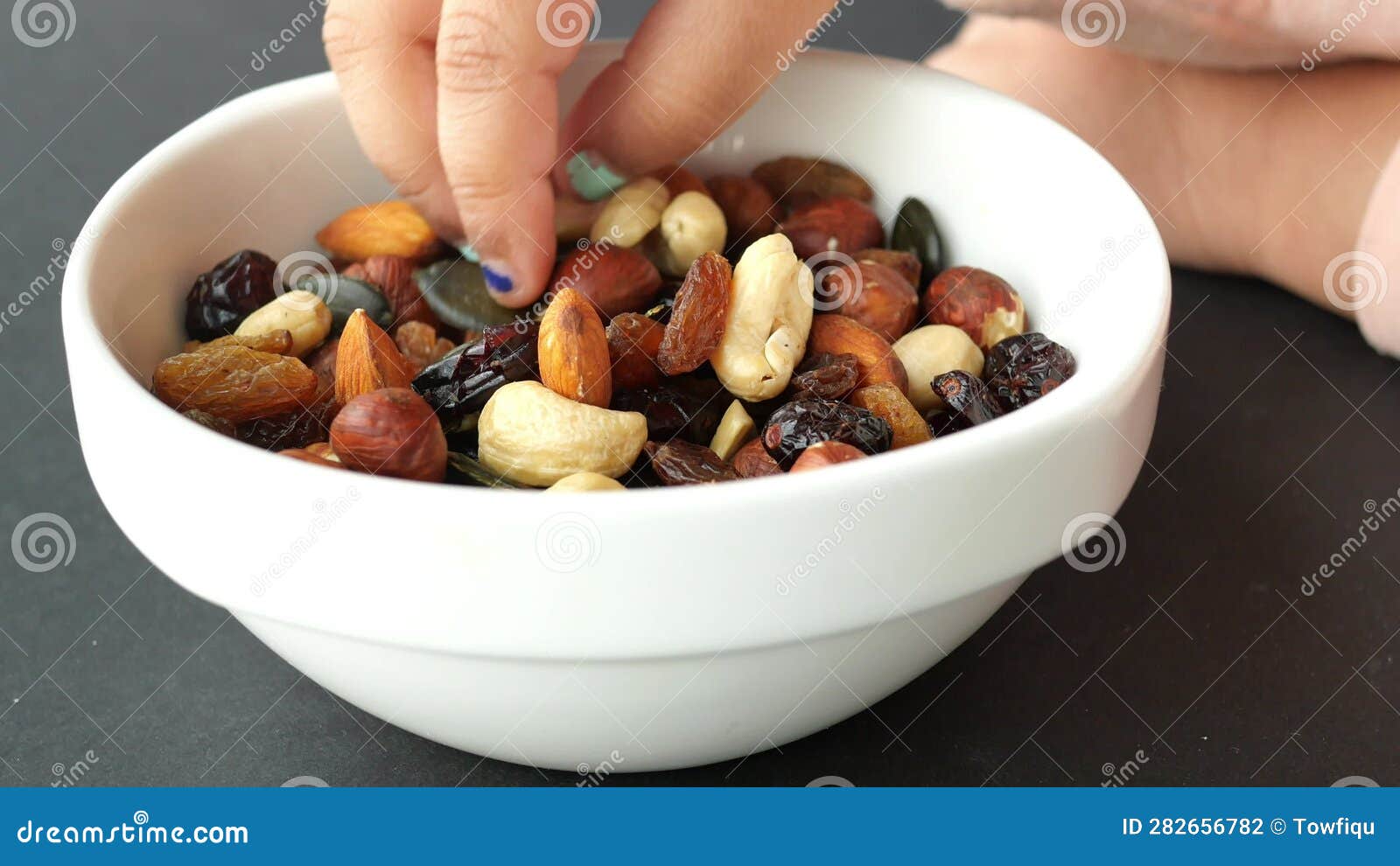 Child Hand Pick Nuts from a Mixed Nut Bowl on Table Stock Footage ...
