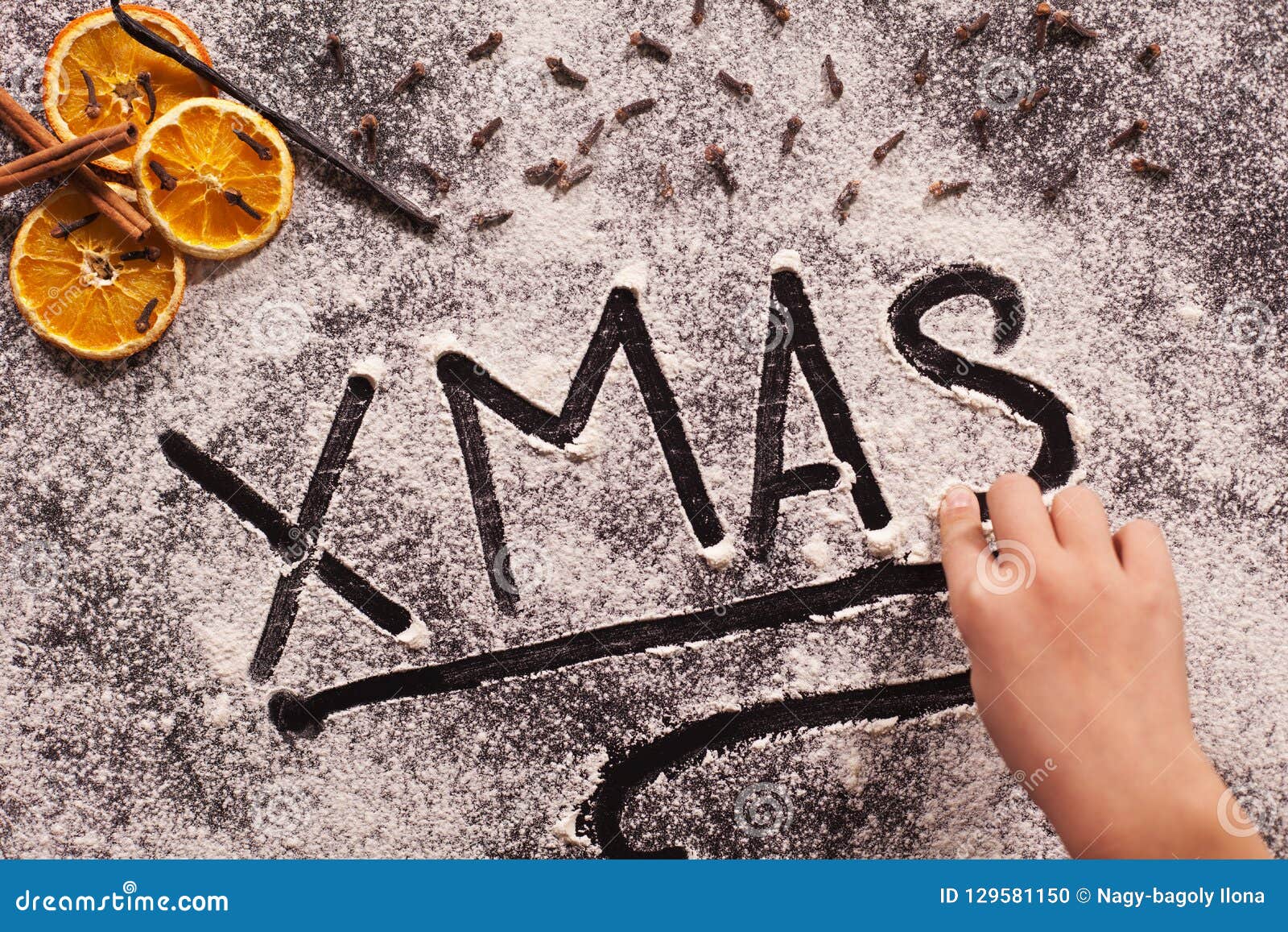 Child Hand Writing Xmas in the Flour Spread on the Table Stock Photo ...