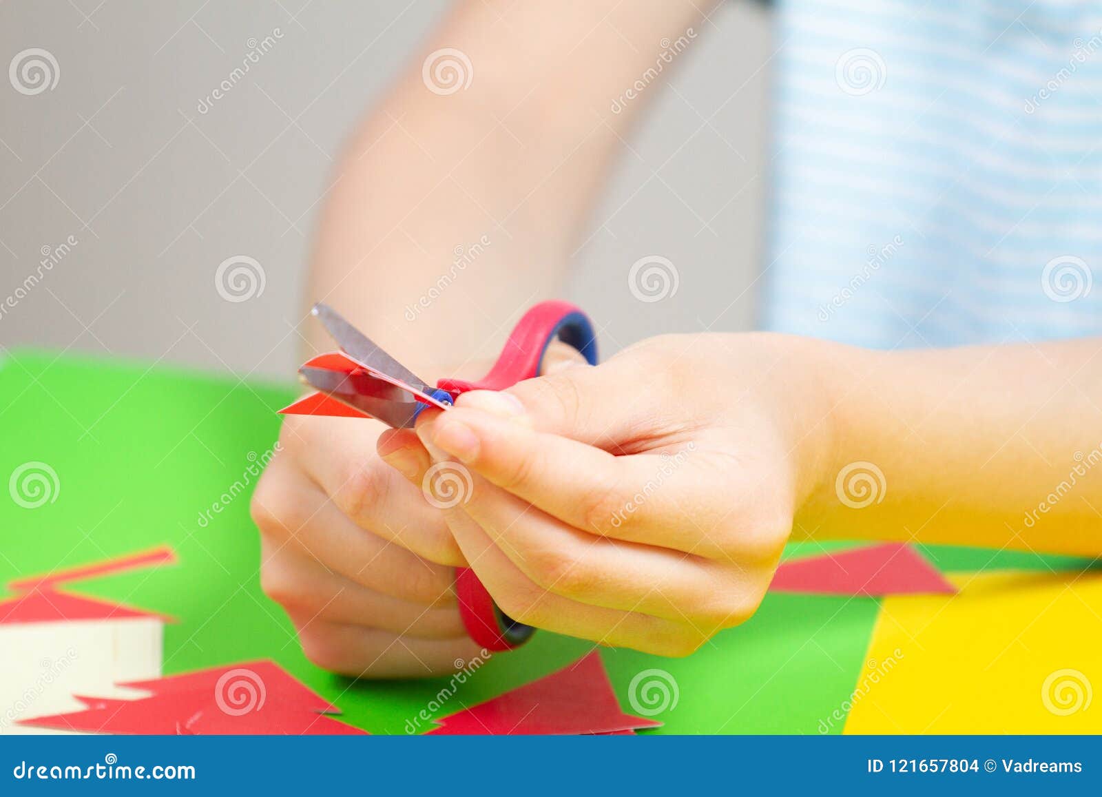 Child Hands Cutting Colored Paper with Scissors at the Table Stock ...