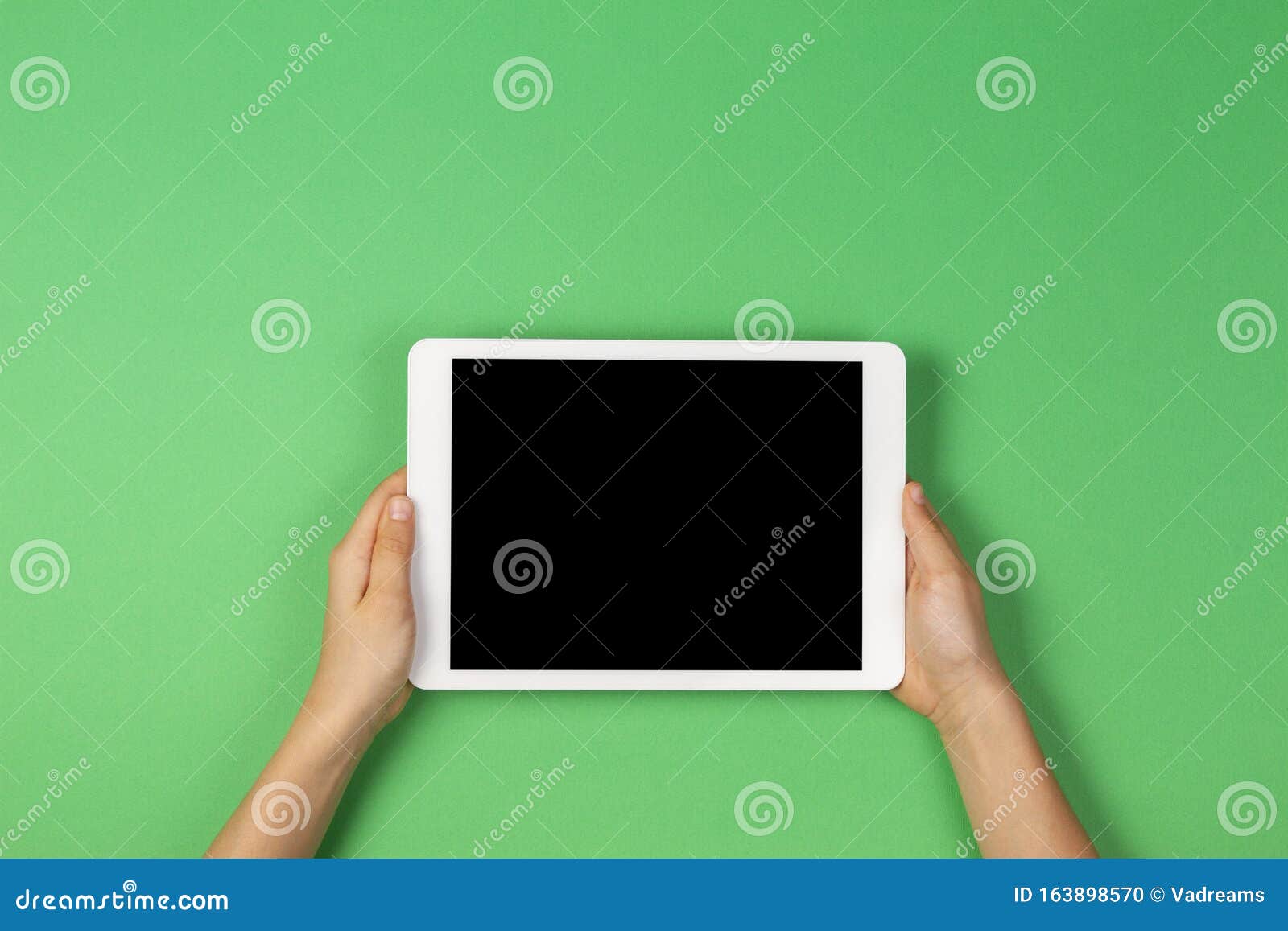 Child Hands Holding Tablet Computer on Light Green Background Stock ...