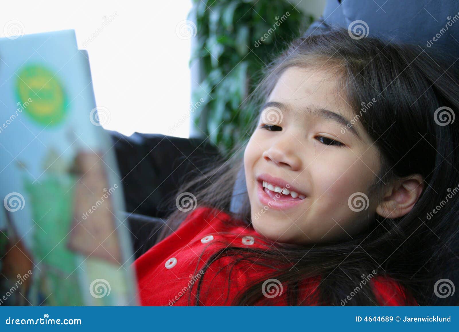 Child Happily Reading a Book Stock Image - Image of emotion, expression ...