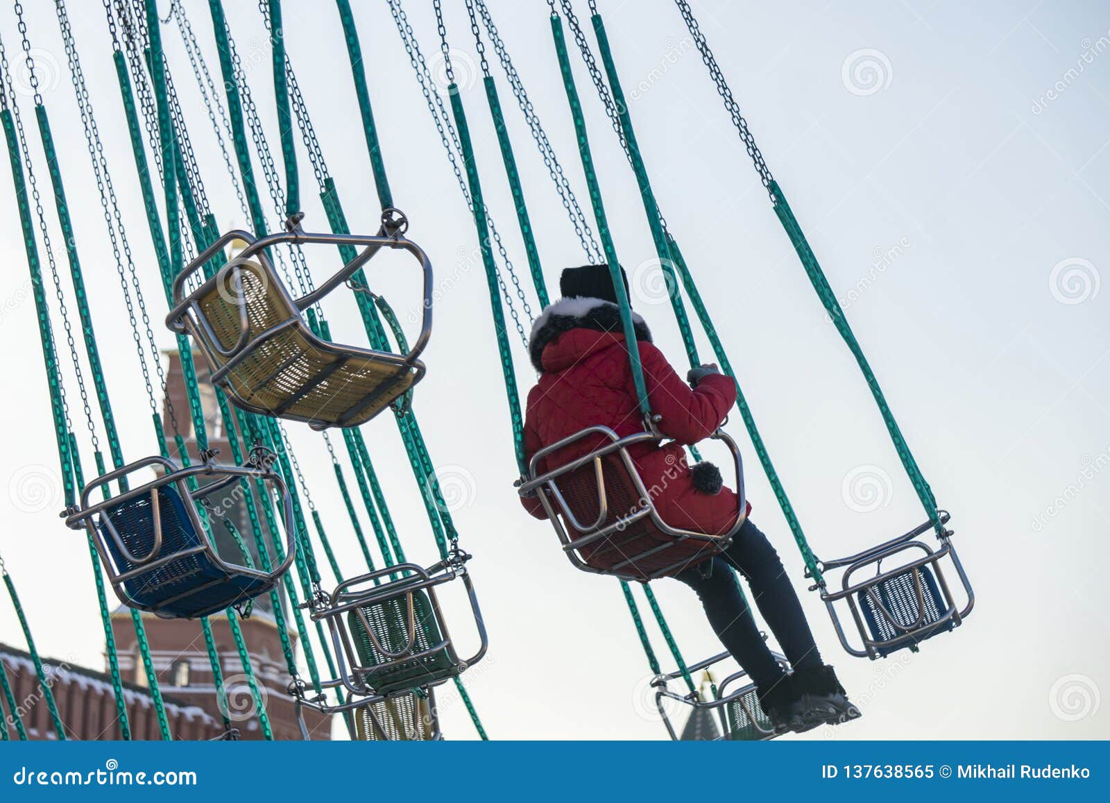 Child Having Fun Riding on a Chain Carousel in the Amusement Park B ...