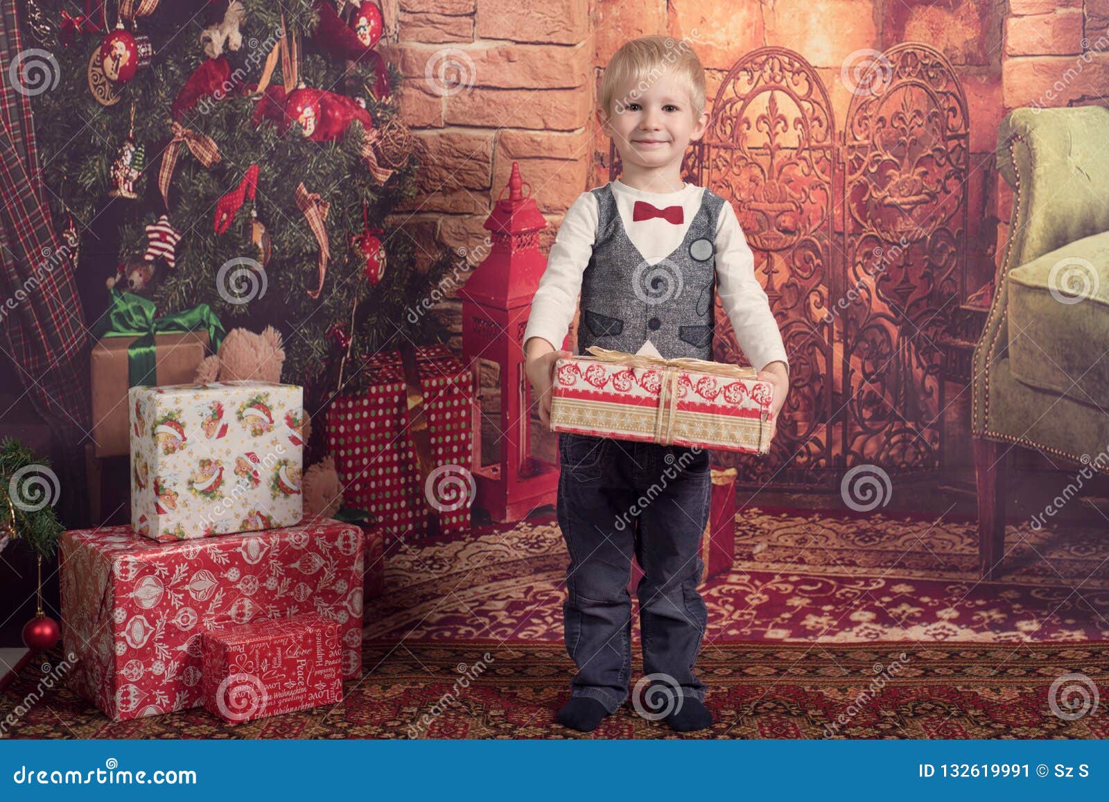 Child holding a gift box stock image. Image of child - 132619991