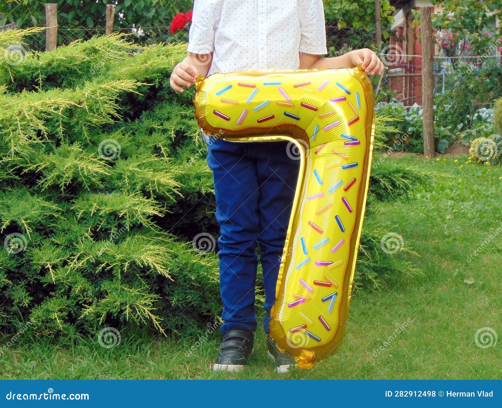 A Child is Holding a Number Seven Balloon Stock Photo - Image of ...