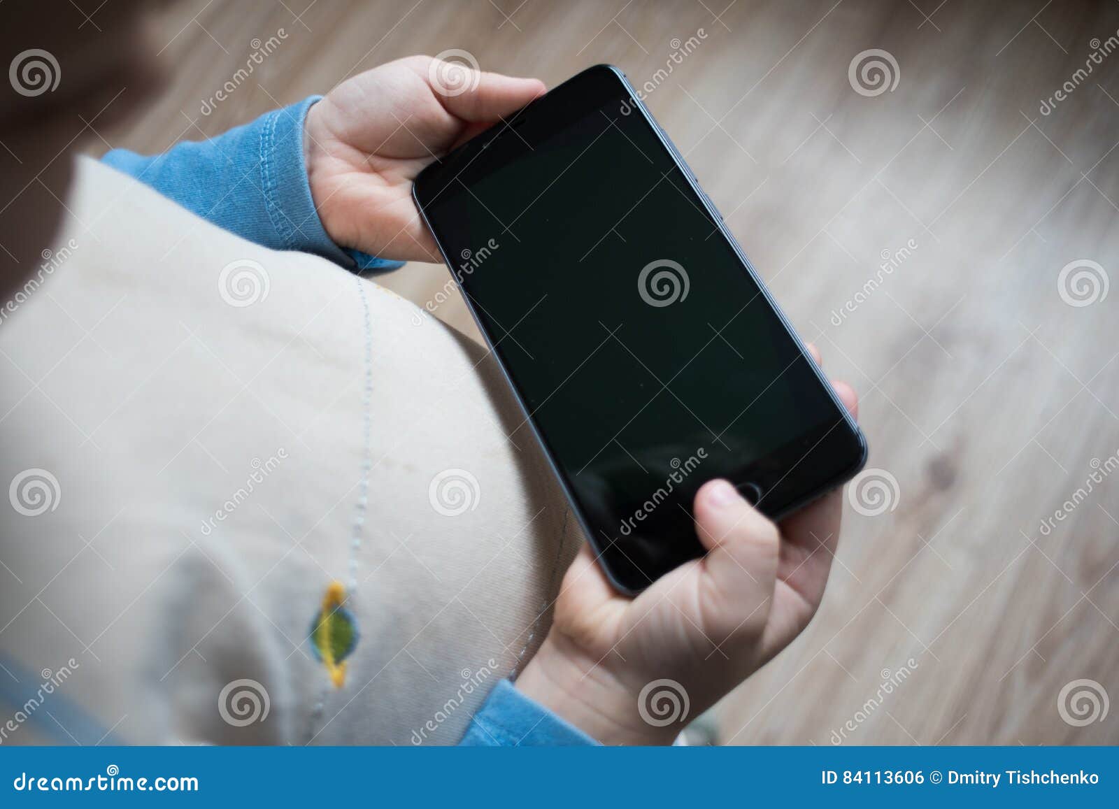 The Child is Holding a Phone in His Hand Stock Photo - Image of little ...