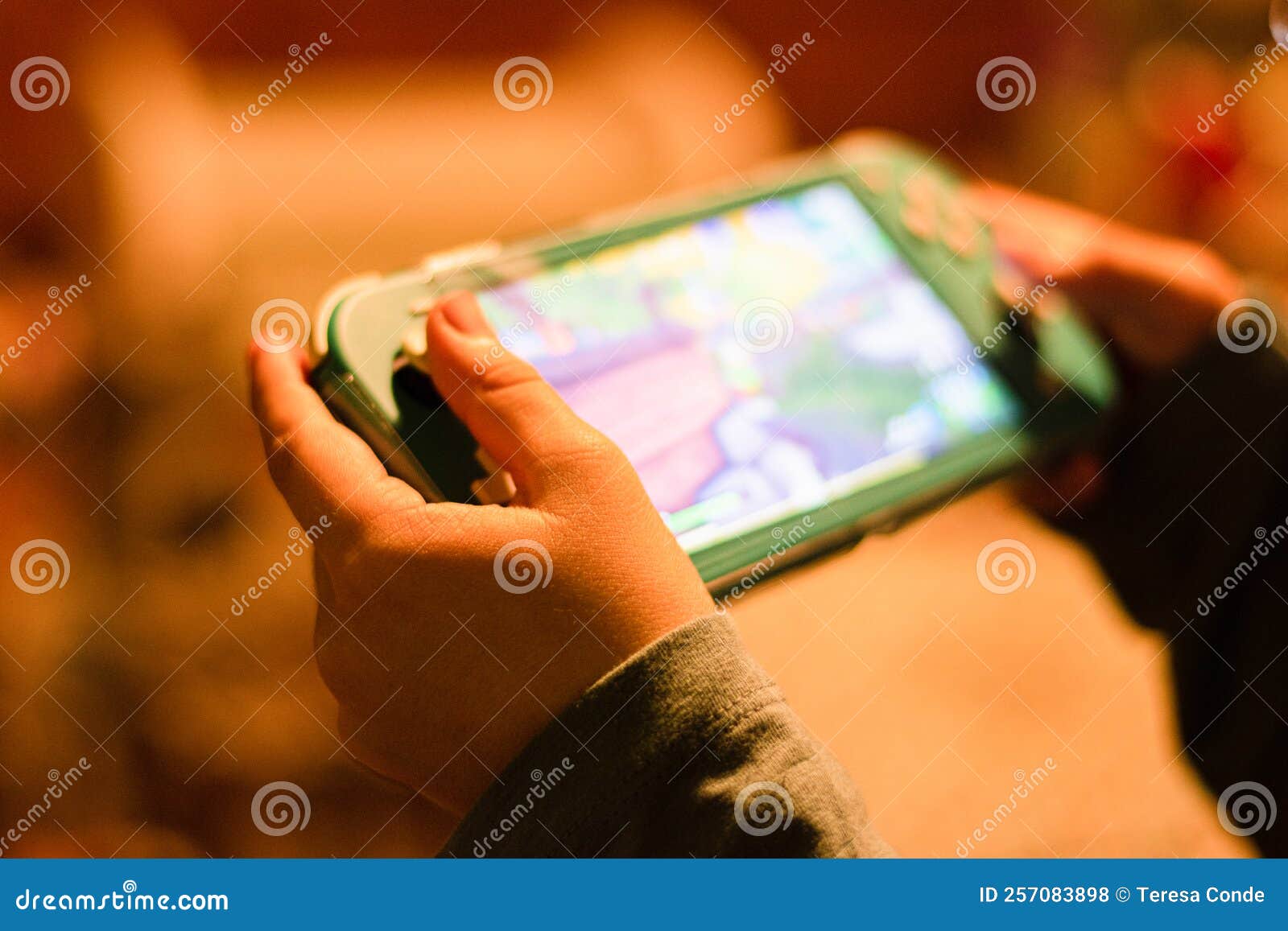 A Child Holding and Playing a Video Game Console Stock Photo - Image of ...