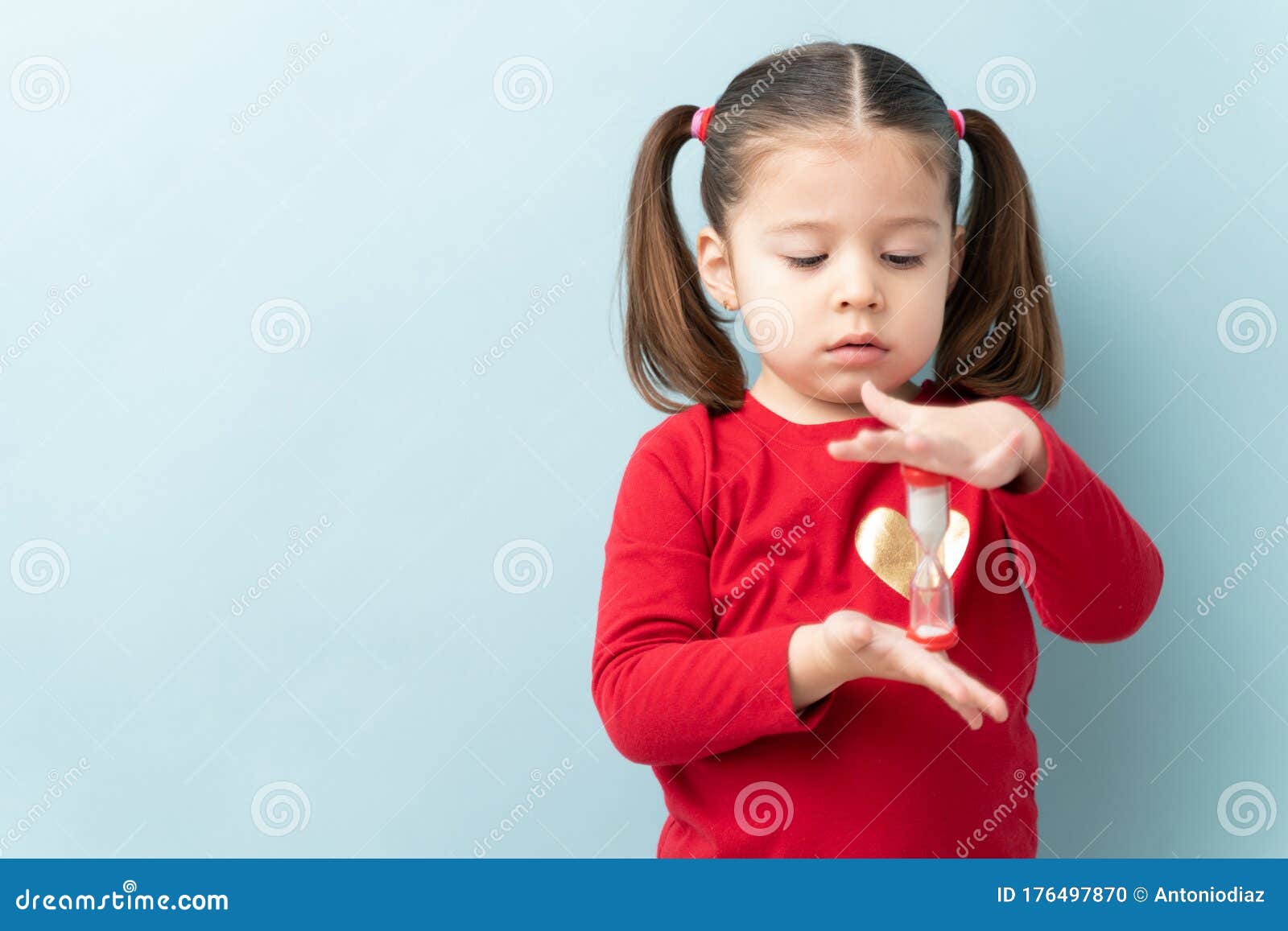 Child Holding a Sand Timer during Timeout Stock Photo - Image of space ...