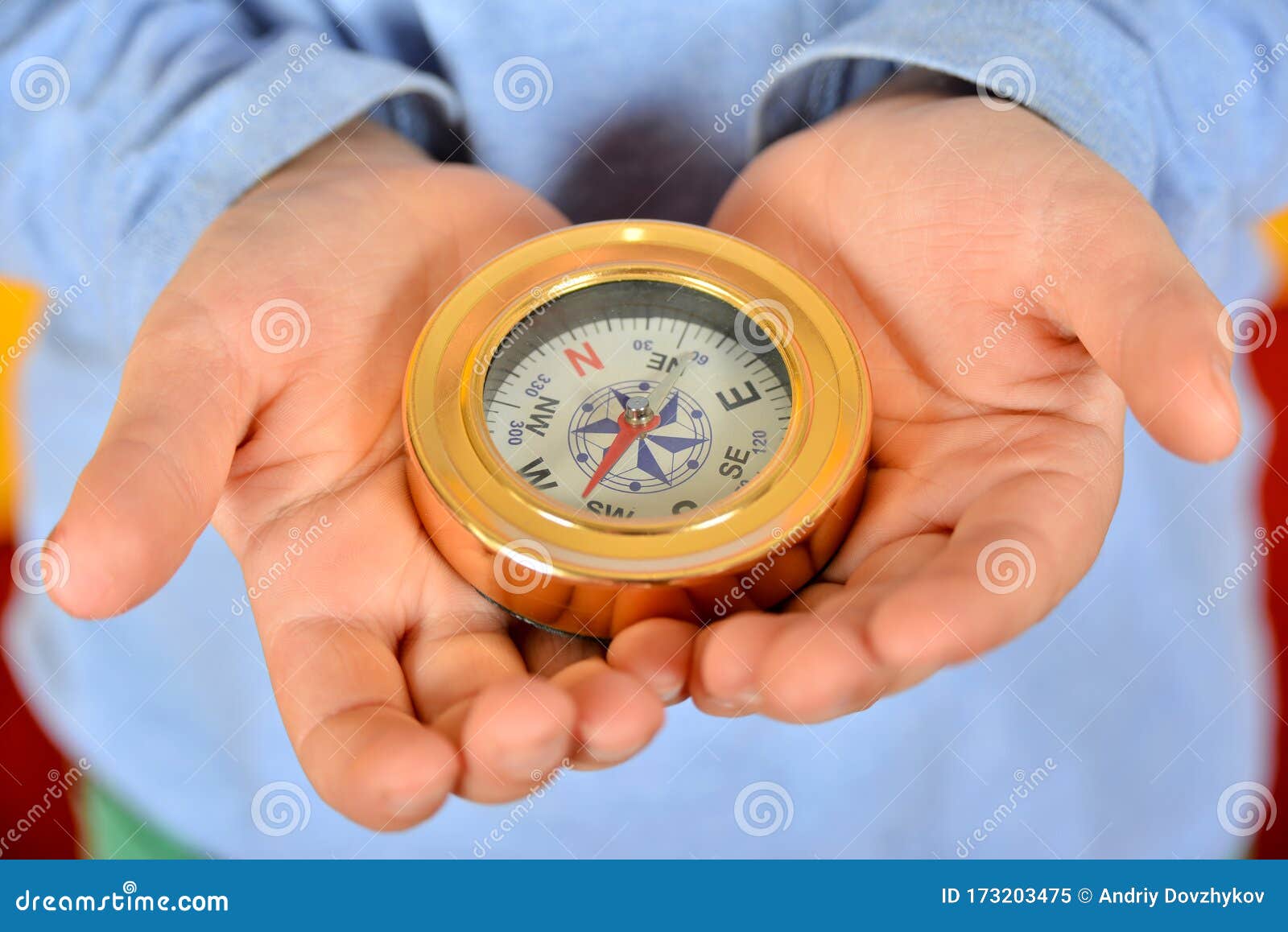 The Child Holds a Compass in His Hands and Looks at the Direction of ...