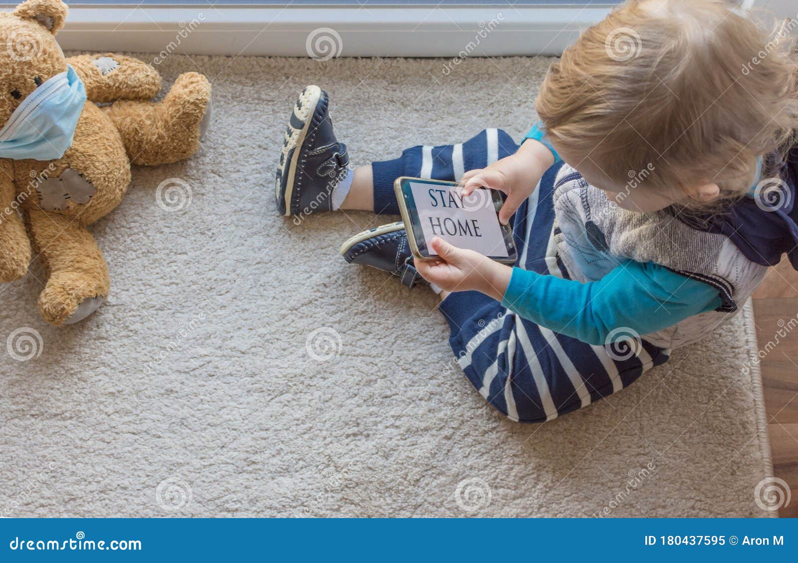Child in Home Quarantine Playing at the Window with the Phone with Stay ... Child in Home Quarantine Playing at the Window with the Phone with Stay ...