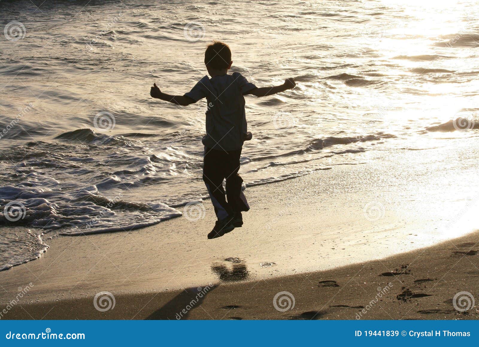 Child jumping on beach stock image. Image of male, energetic - 19441839