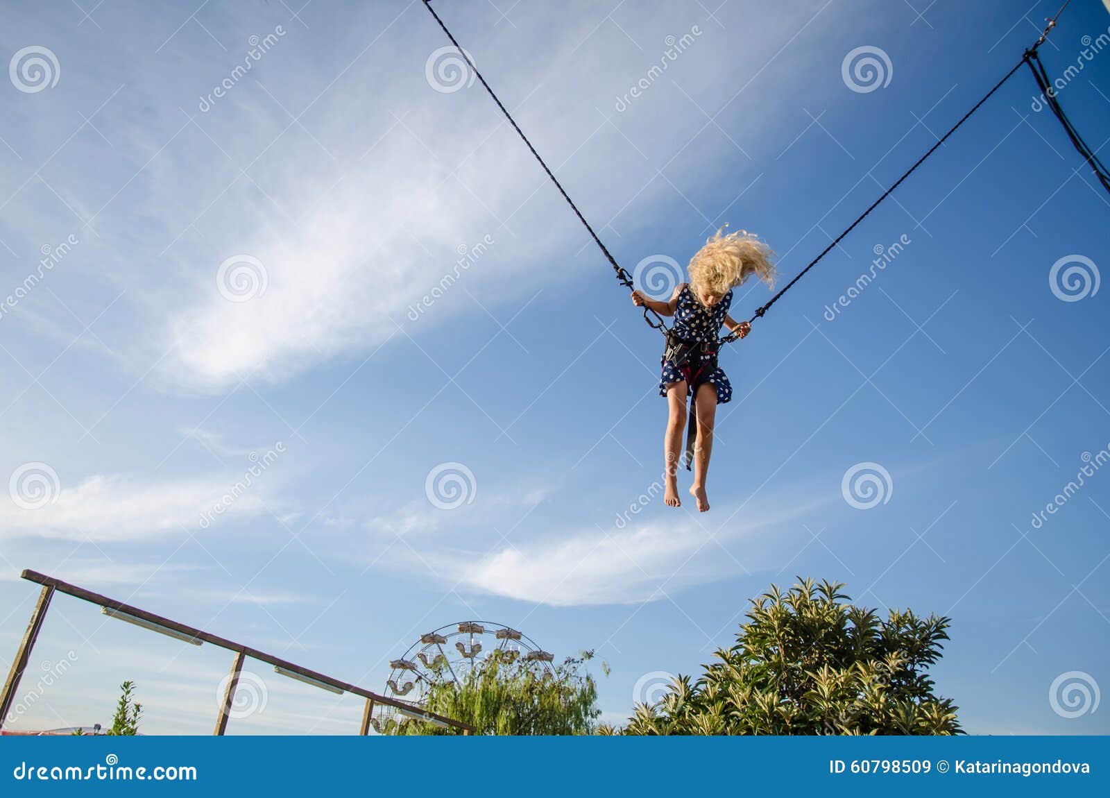 Child Jumping in Bungee Attraction Stock Image - Image of high, blowing ...