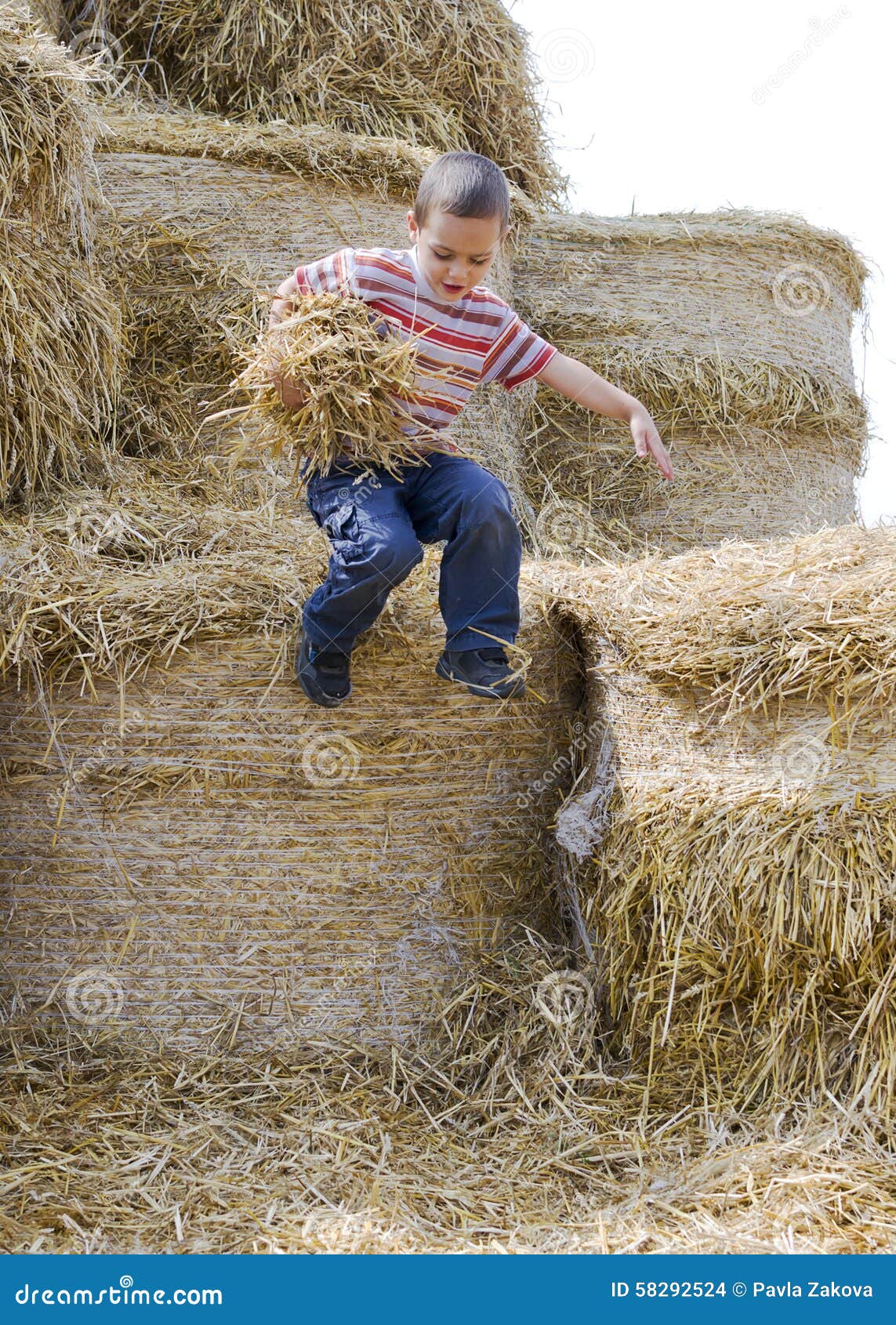 Child jumping in haystack stock photo. Image of trowing - 58292524