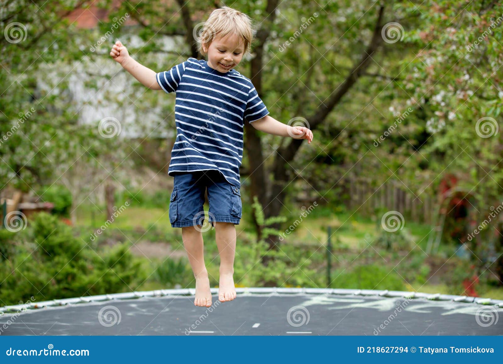 Child, Jumping High on a Trampoline Stock Photo - Image of outdoors ...