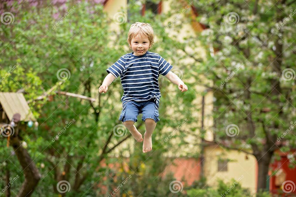 Child, Jumping High on a Trampoline Stock Photo - Image of jump ...
