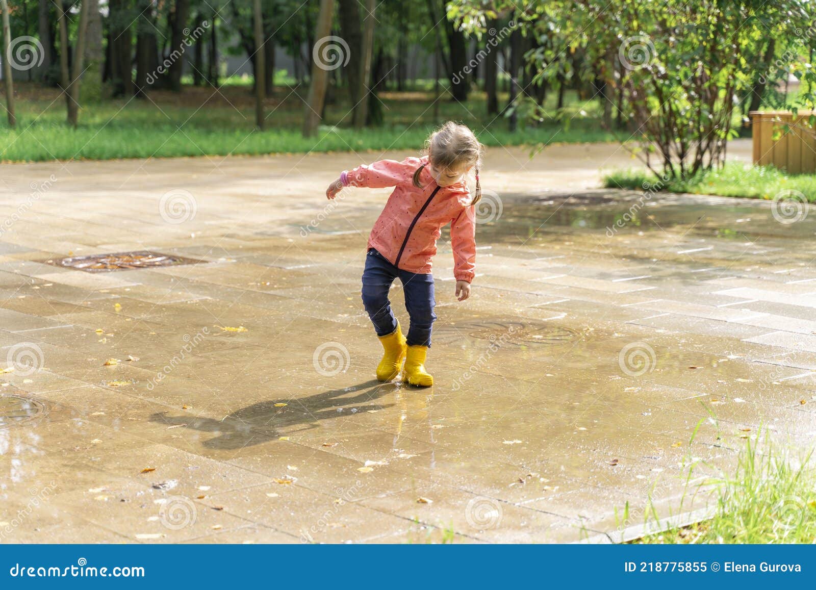 Child Jumping and Playing in a Puddle after Rain Stock Image - Image of ...
