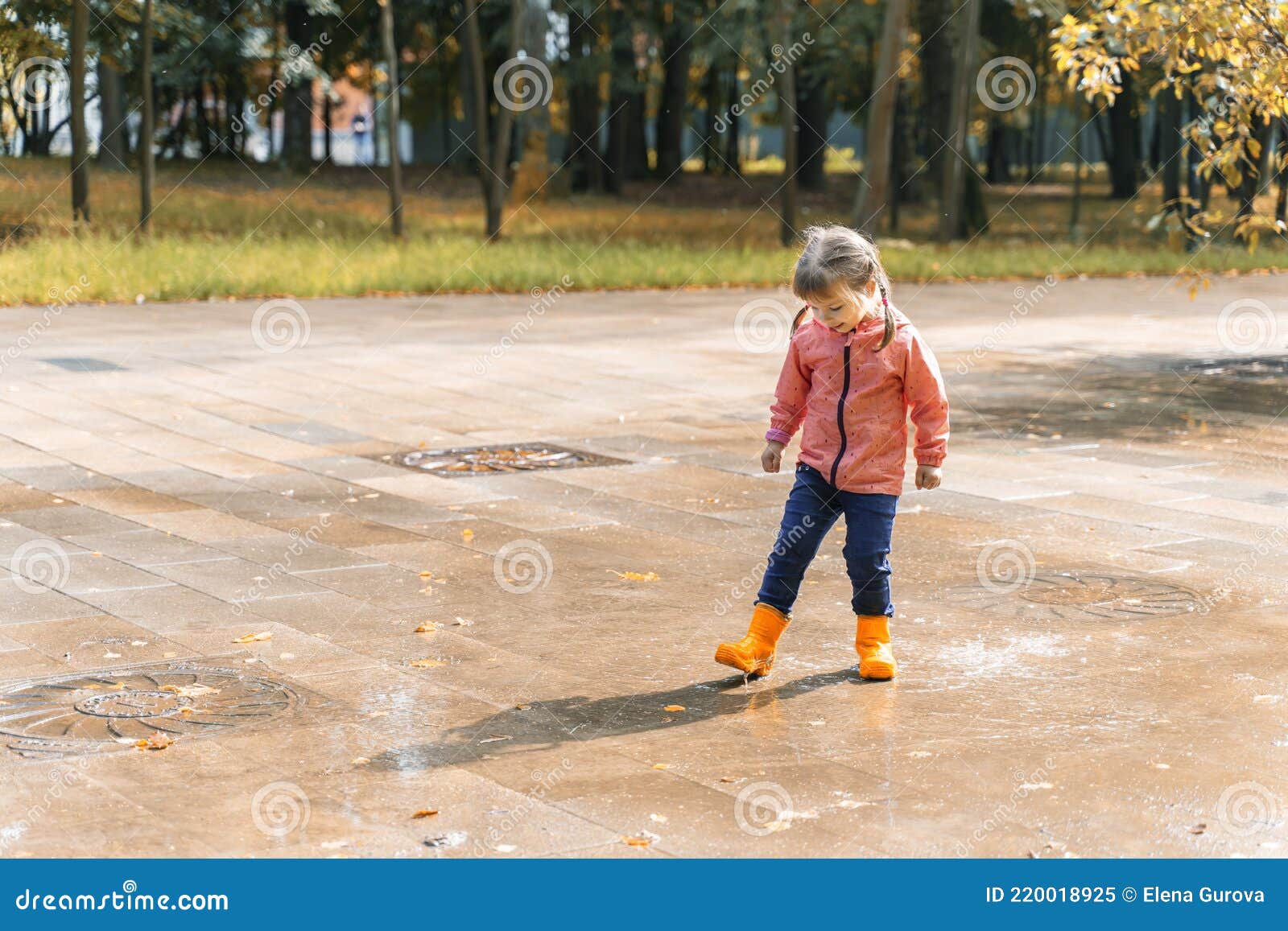 Child Jumping and Playing in a Puddle after Rain Stock Image - Image of ...