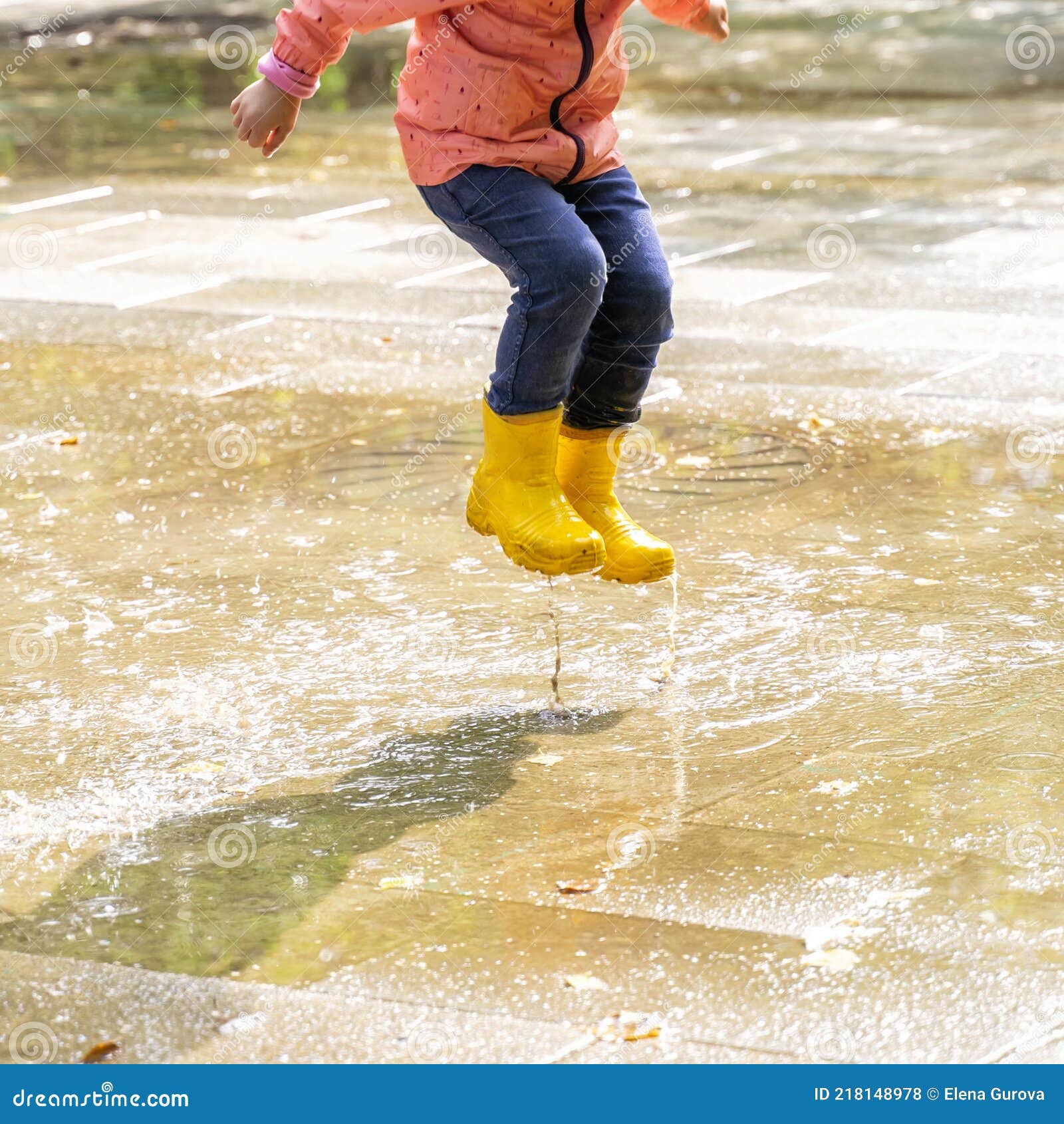 Child Jumping and Playing in a Puddle after Rain Stock Photo - Image of ...