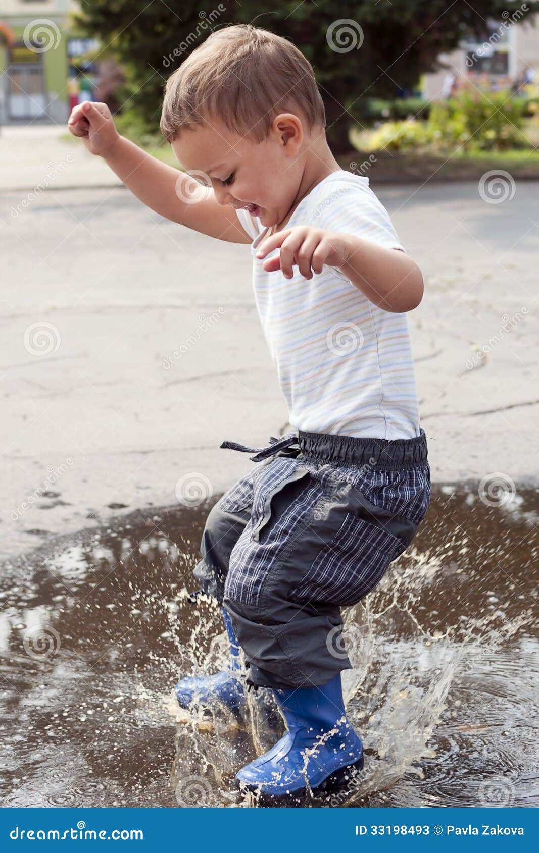 Child jumping in puddle stock image. Image of park, jacket - 33198493