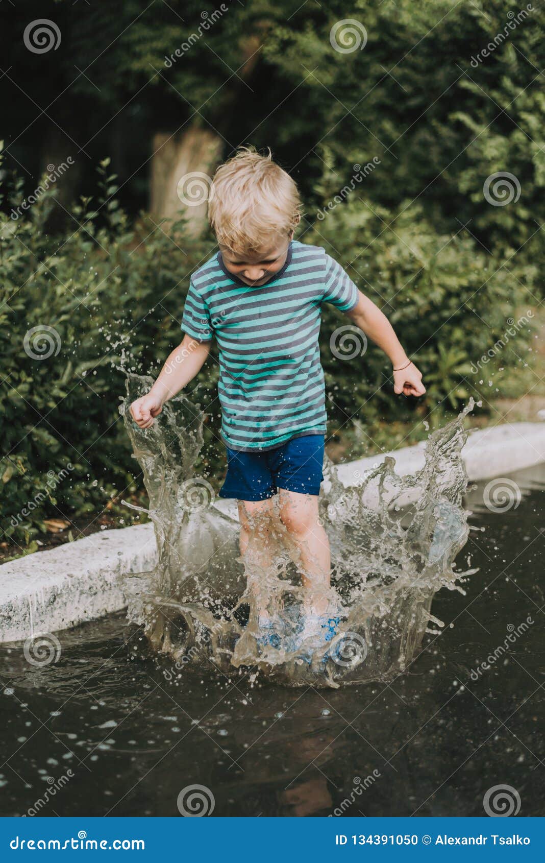 Little Boy Jumping in a Puddle in Summer Stock Photo - Image of blue ...