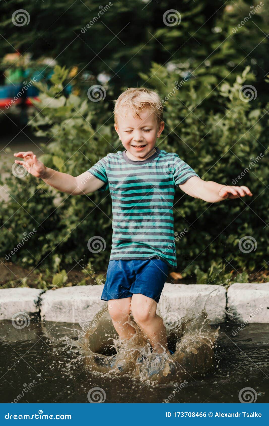 Little Boy Jumping in a Puddle in Summer Stock Photo - Image of ...