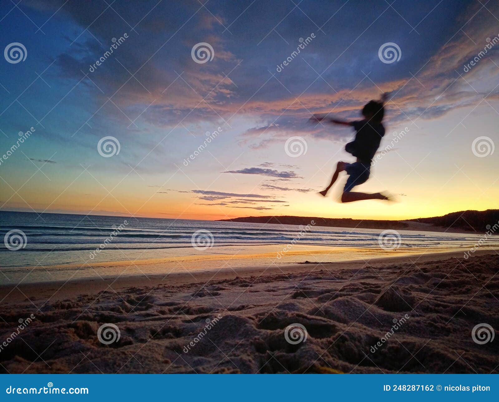 Child Jumping on Seashore at Sunset Stock Photo - Image of shore, dusk ...