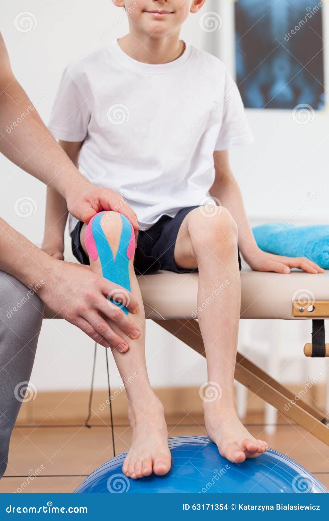 Kinesio Taping Of Knee With Blue Strips For Trauma In Clinic. Stock ...