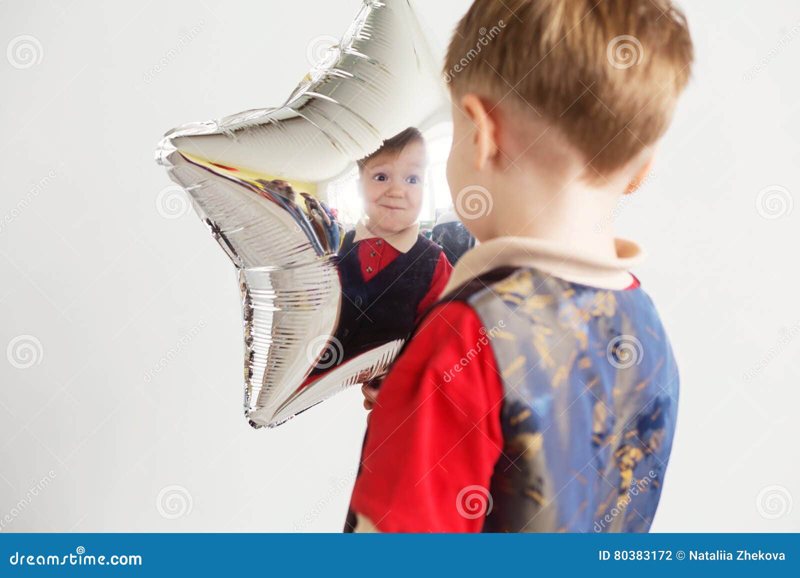Child Laughing Looking at the Reflection in a Distorted Mirror Stock ...