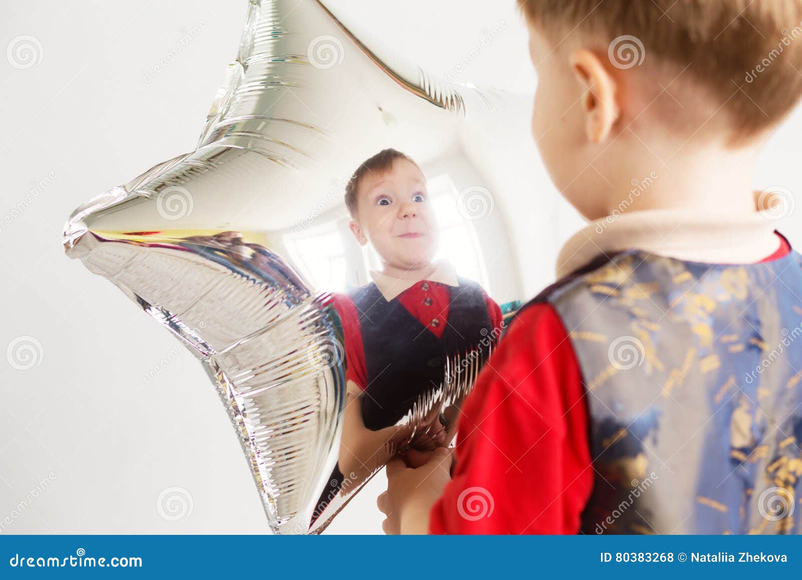 Child Laughing Looking at the Reflection in a Distorted Mirror Stock ...