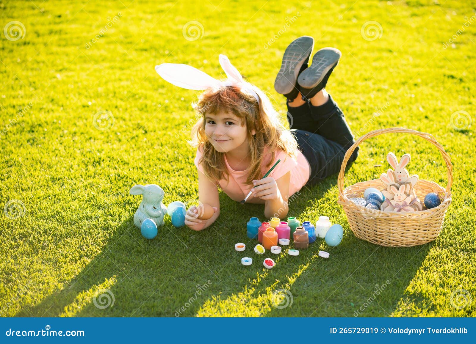 Child Laying on Grass in Park Wit Easter Eggs. Child Boy with Easter ...