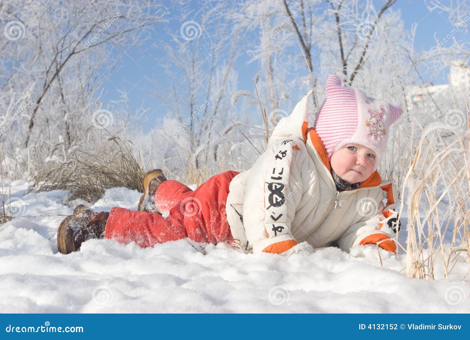 A child lays on the snow stock photo. Image of people - 4132152