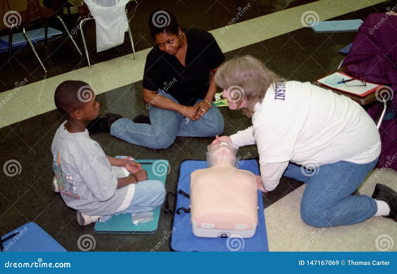 2 CPR Instructors are Teaching CPR in a Community CPR Class in ...