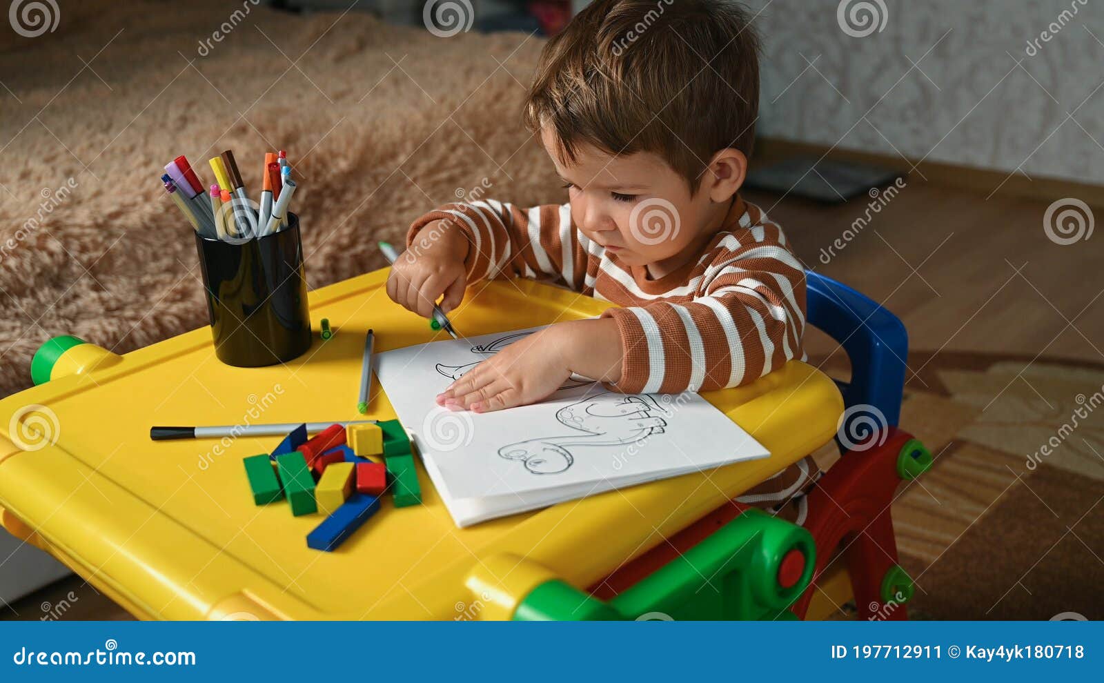 The child learns to draw stock image. Image of activity - 197712911