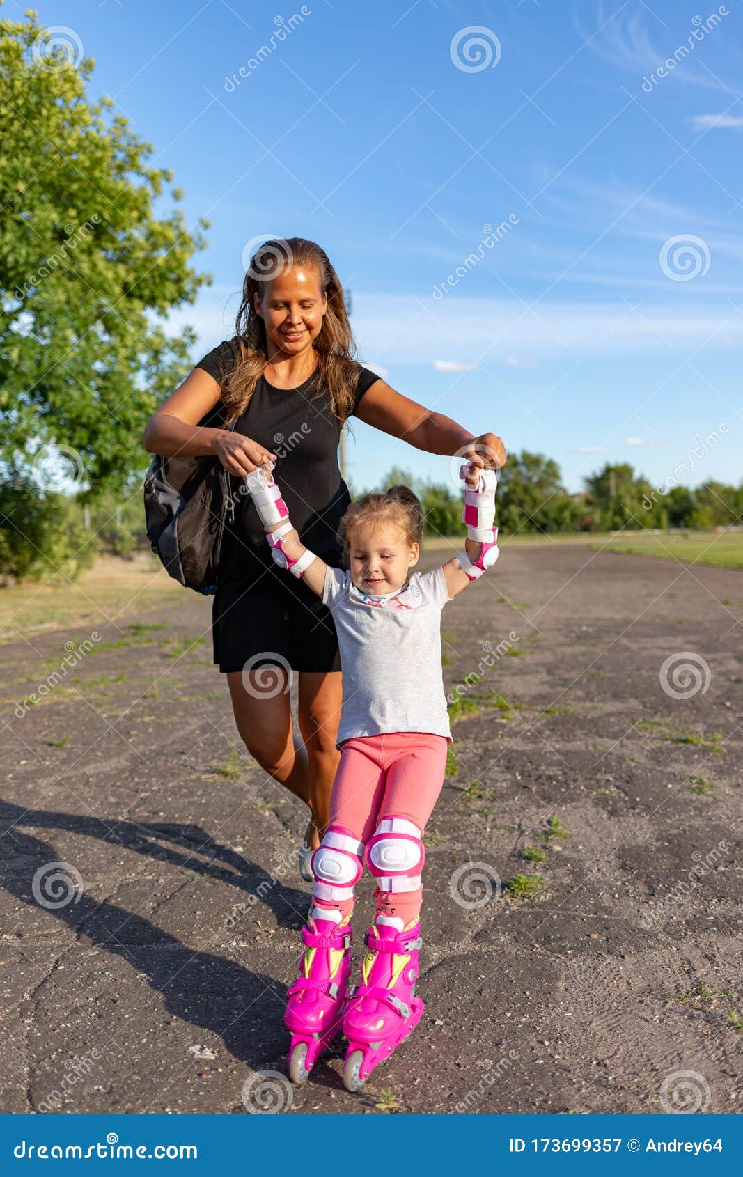 Child Learns To Roller Skate. Roller Skating Stock Image - Image of ...