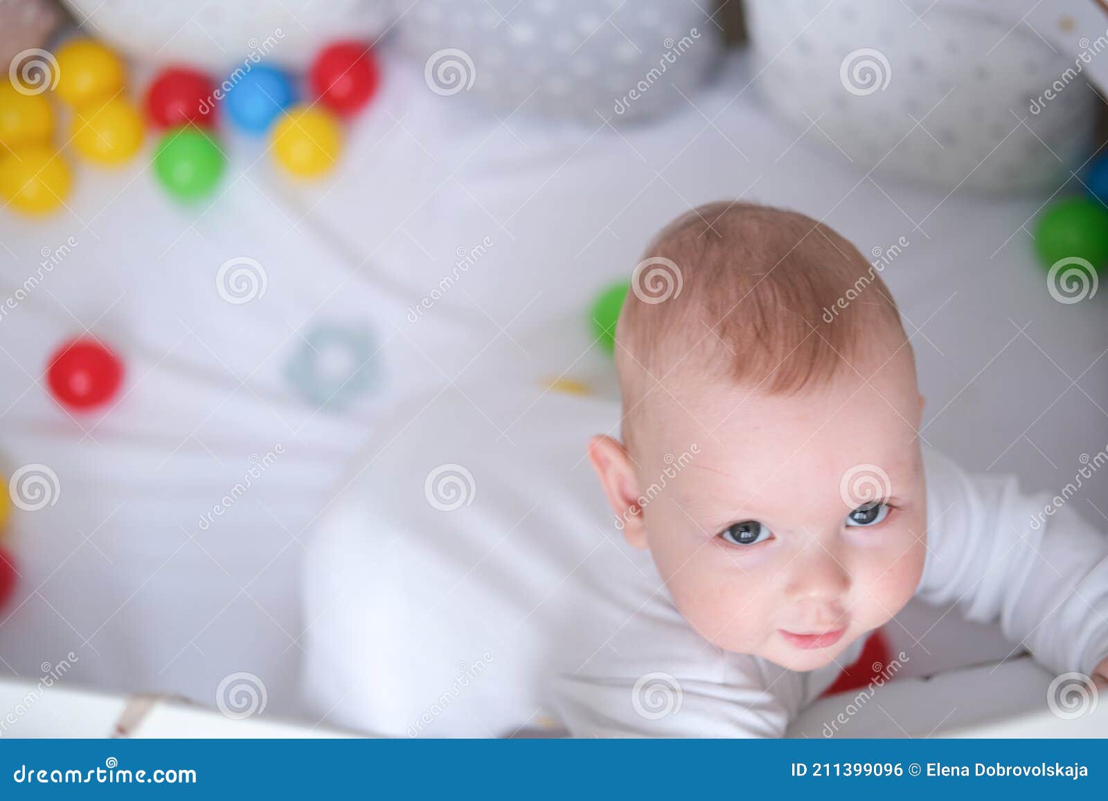 The Child Learns To Walk in a Crib and Takes the First Steps Stock ...