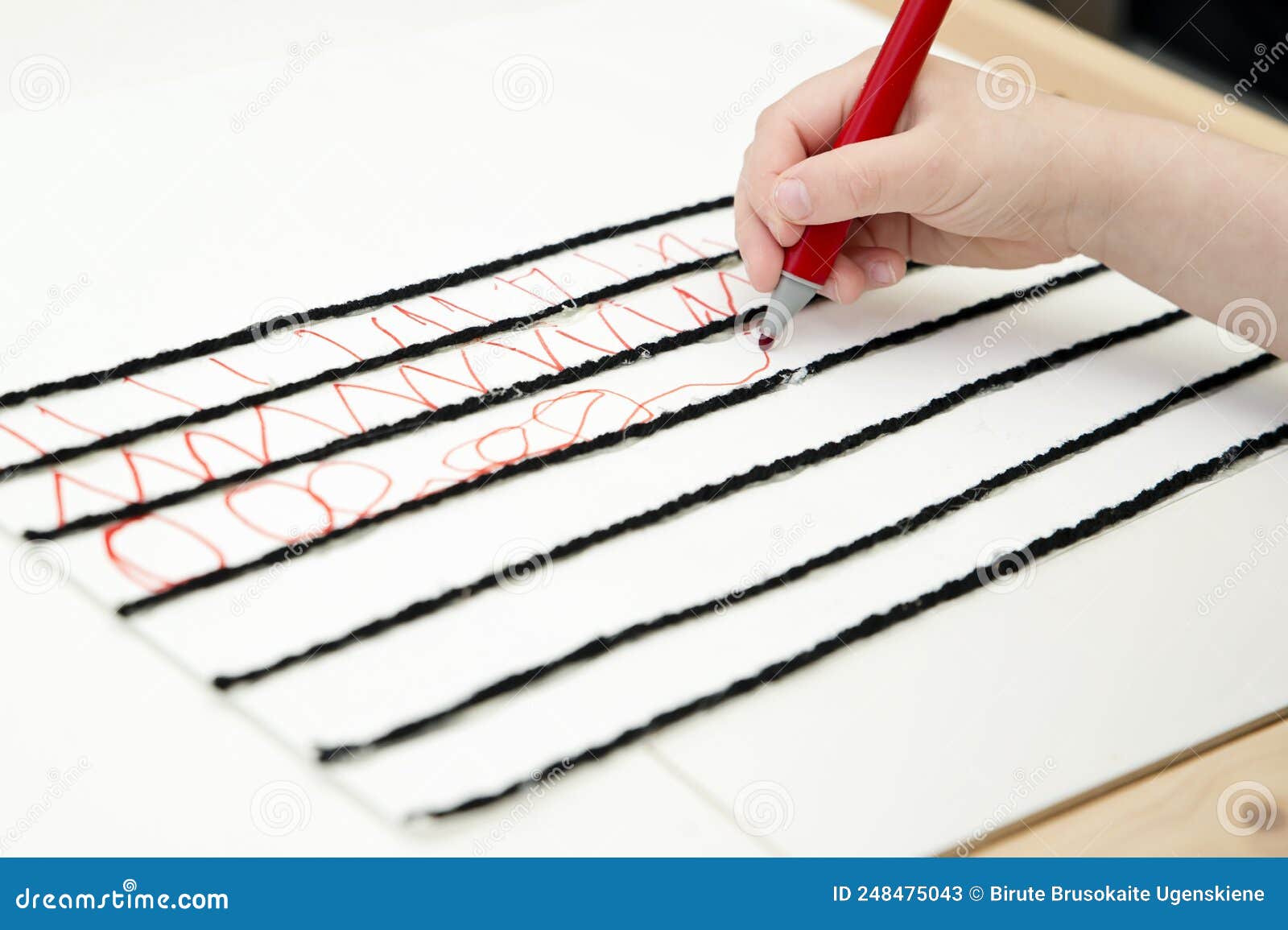 Child Learns To Write Symbols. Hand Training Tasks. Stock Image - Image ...