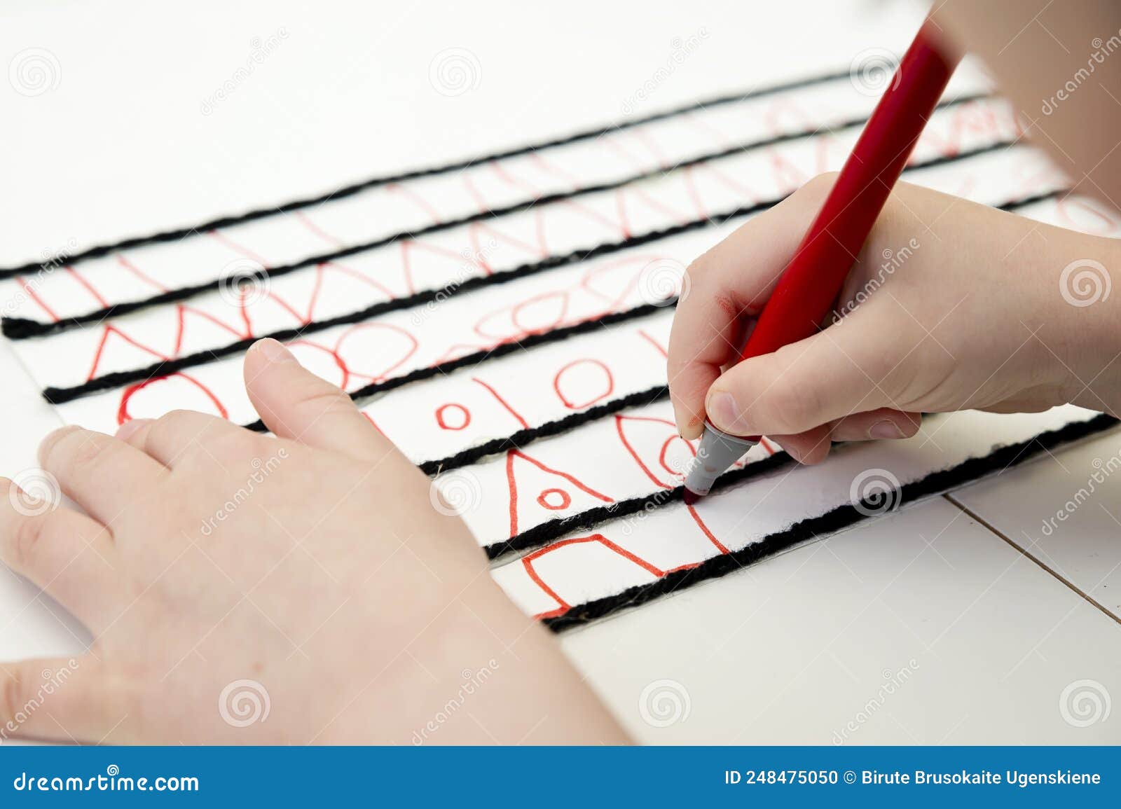 Child Learns To Write Symbols. Hand Training Tasks. Stock Photo - Image ...
