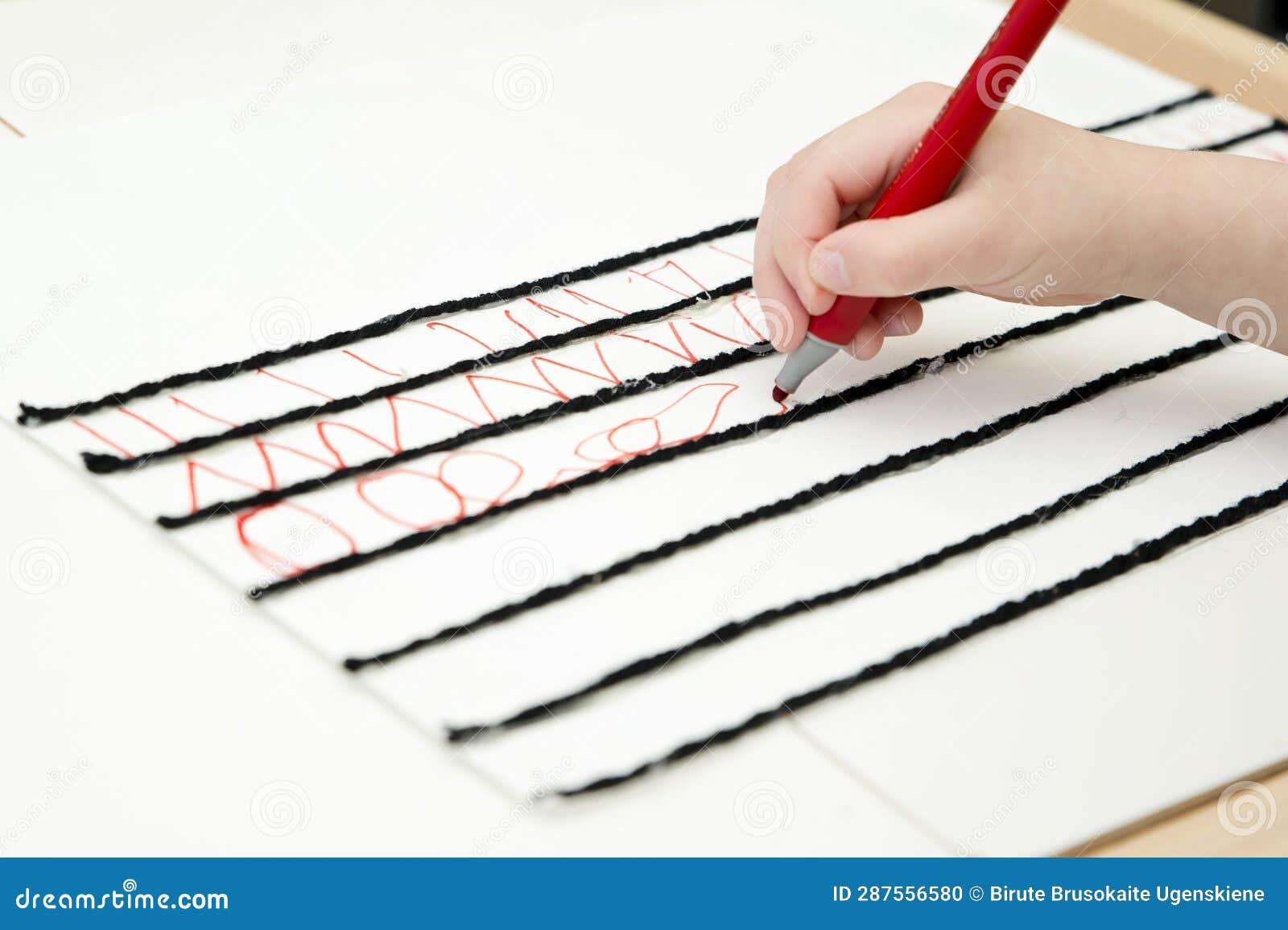 Child Learns To Write Symbols. Hand Training Tasks Stock Photo - Image ...