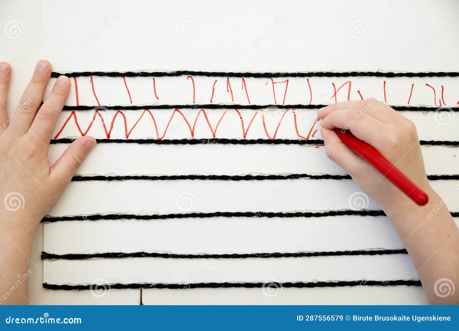 Child Learns To Write Symbols. Hand Training Tasks Stock Image - Image ...