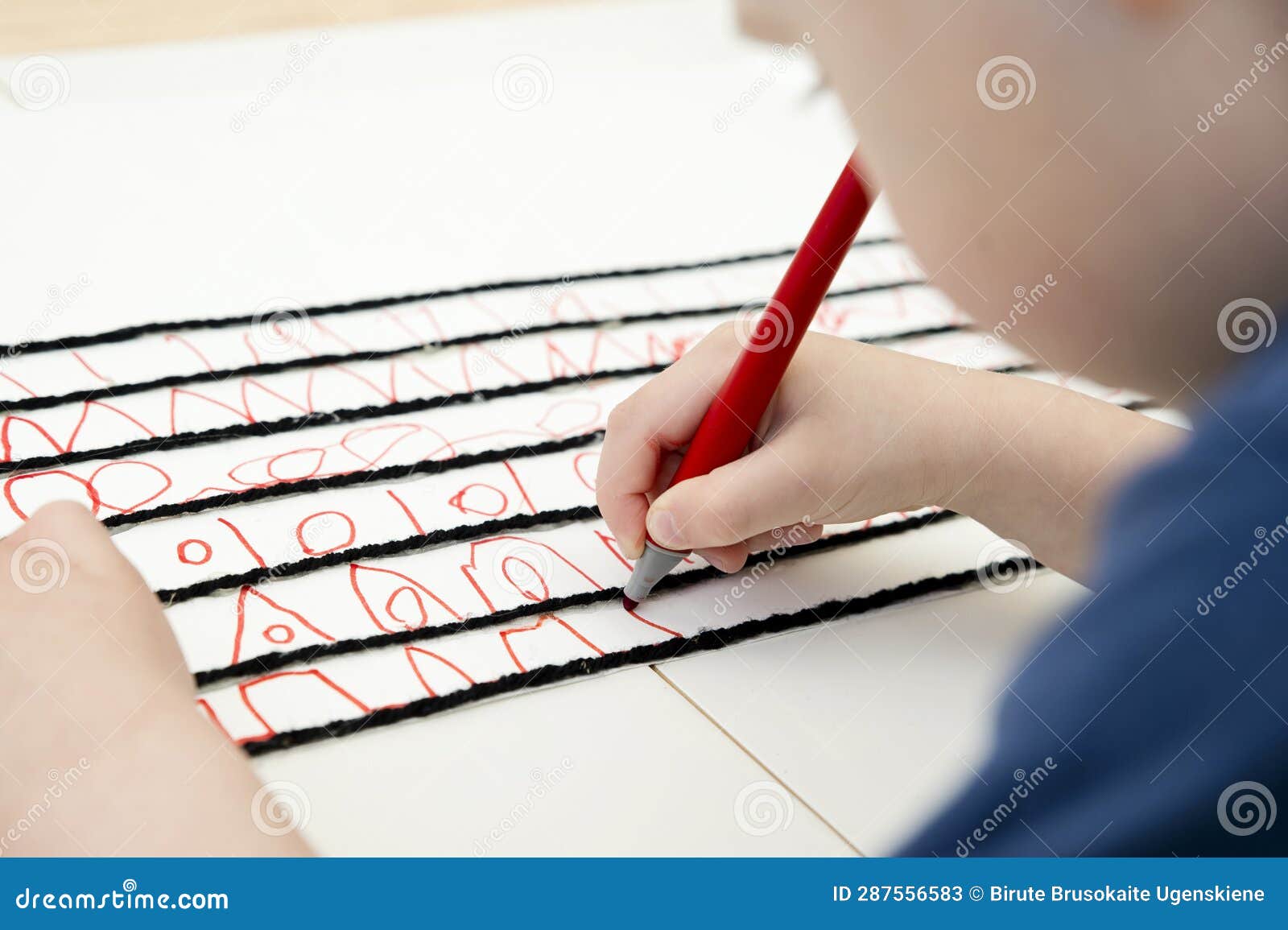 Child Learns To Write Symbols. Hand Training Tasks Stock Image - Image ...