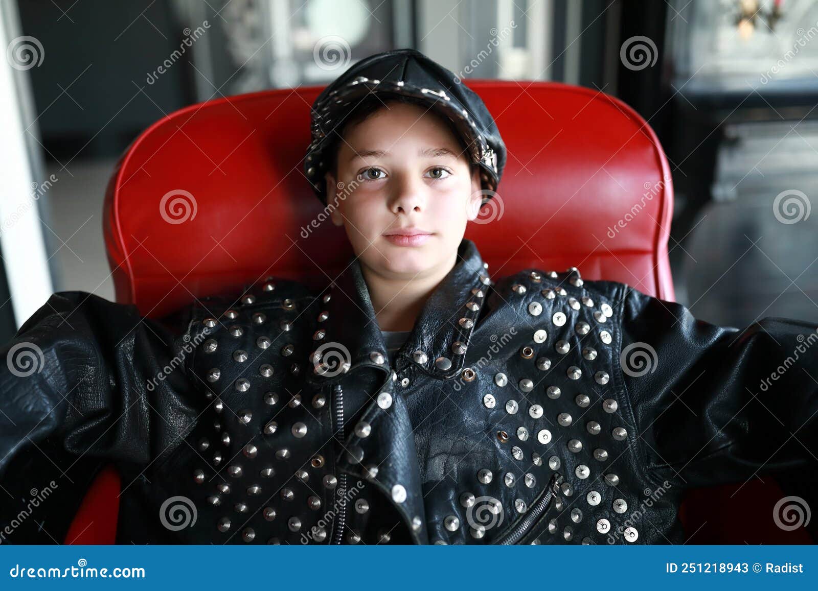 Child in Leather Jacket and Cap Sitting on Chair Stock Image - Image of ...